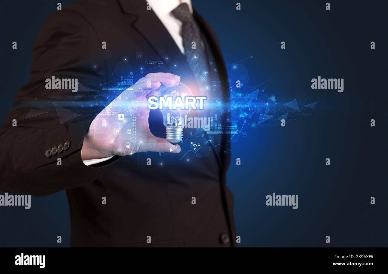 Businessman holding a light bulb Stock Photo - Alamy