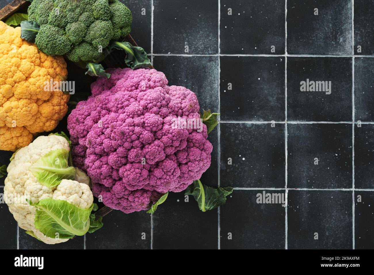 Colorful cauliflower. Various sort of cauliflower on old stone tiles ...