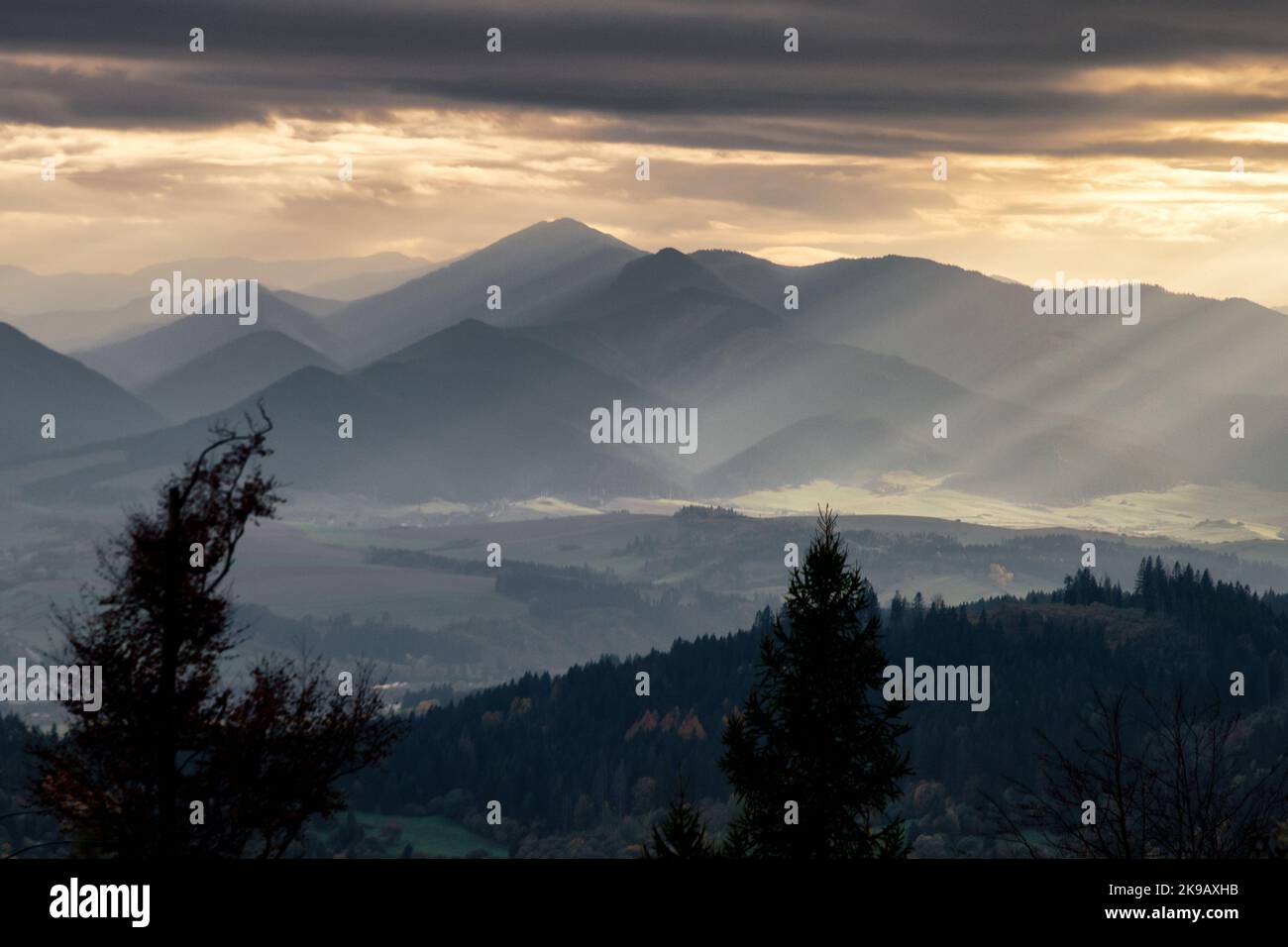 The sun magically shines through a gap through the cloud producing ...