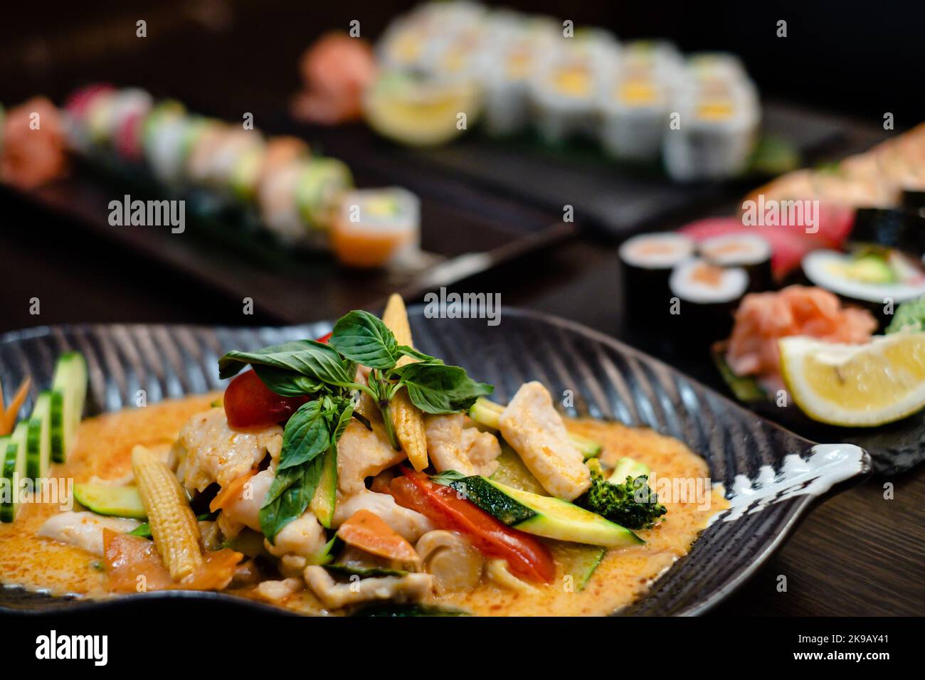 Table with mixed asian food plates Stock Photo - Alamy