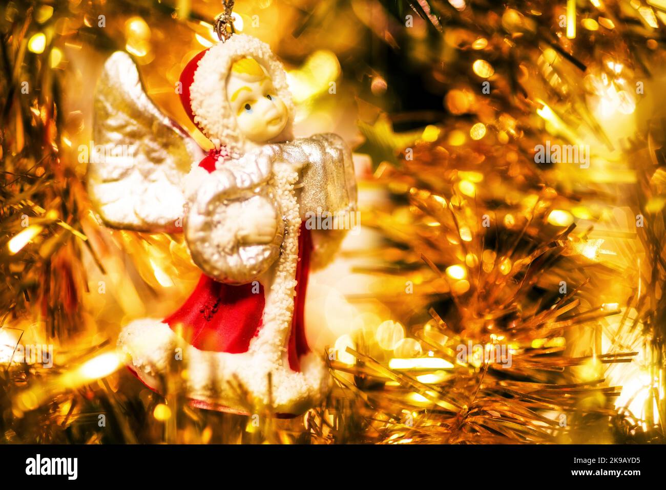 Cute toy angel hanging on decorating a Christmas tree Stock Photo - Alamy