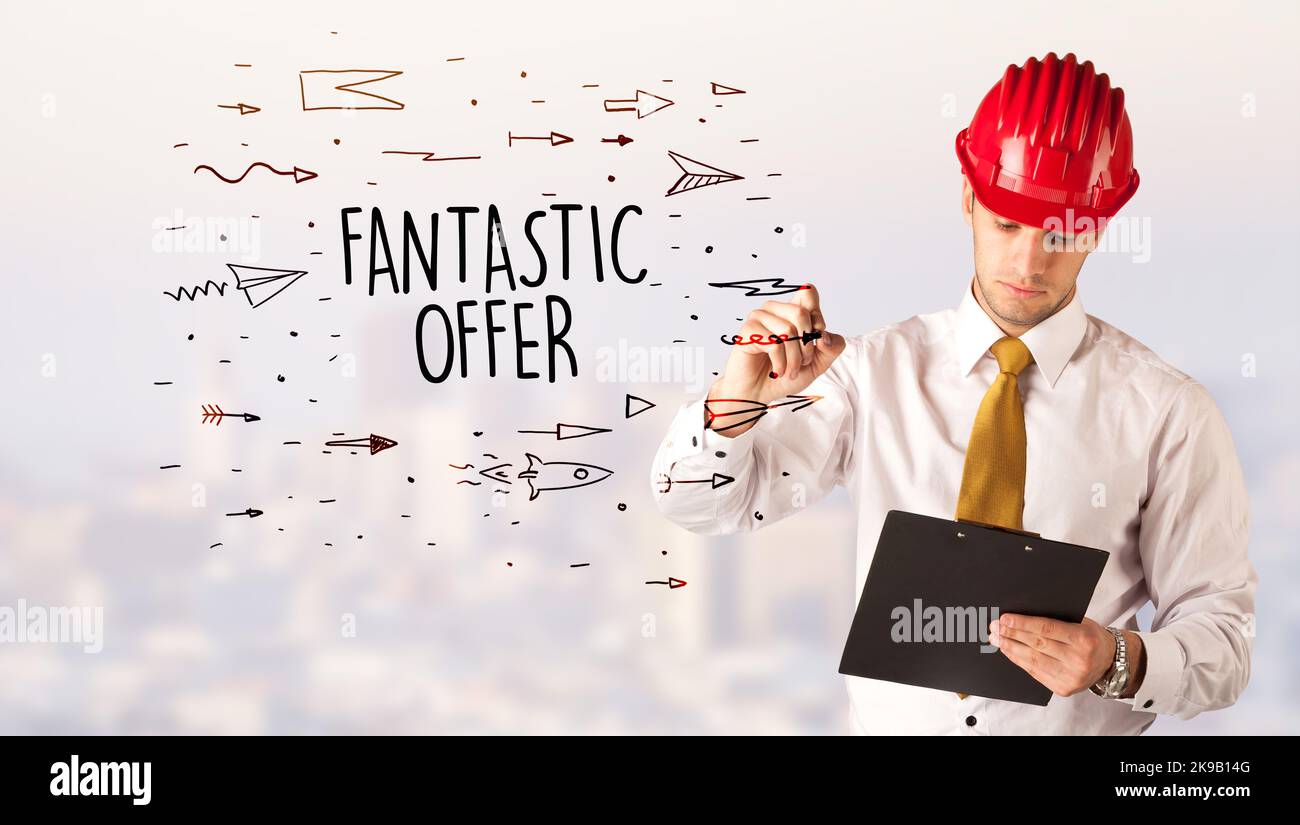Young businessman with helmet drawing sale sign Stock Photo - Alamy