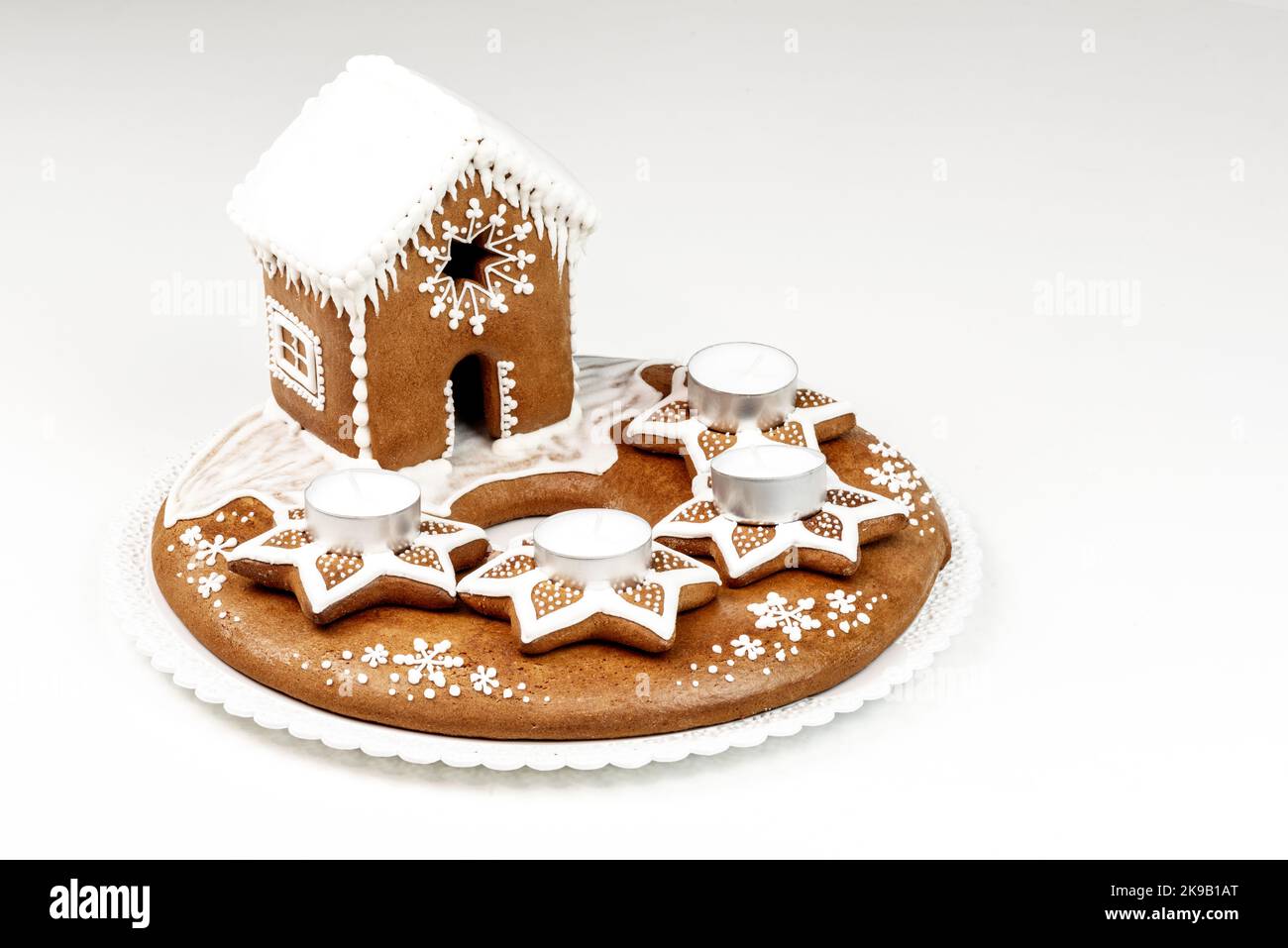 Advent candlestick made of gingerbread cake and house on white ...