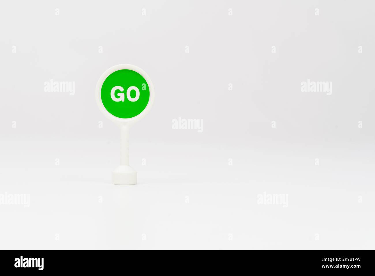 text GO on green traffic sign on white background Stock Photo - Alamy