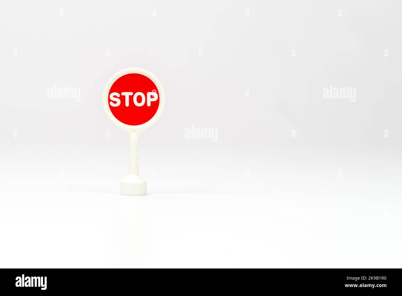 text STOP on red traffic sign on white background Stock Photo - Alamy