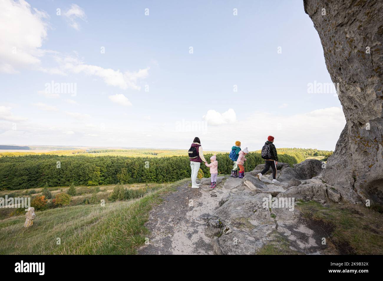 Kids exploring nature. Children wear backpack hiking with mother near ...