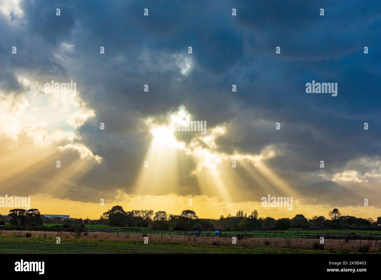 Dramatic skies with sun rays breaking through showing the end of the ...