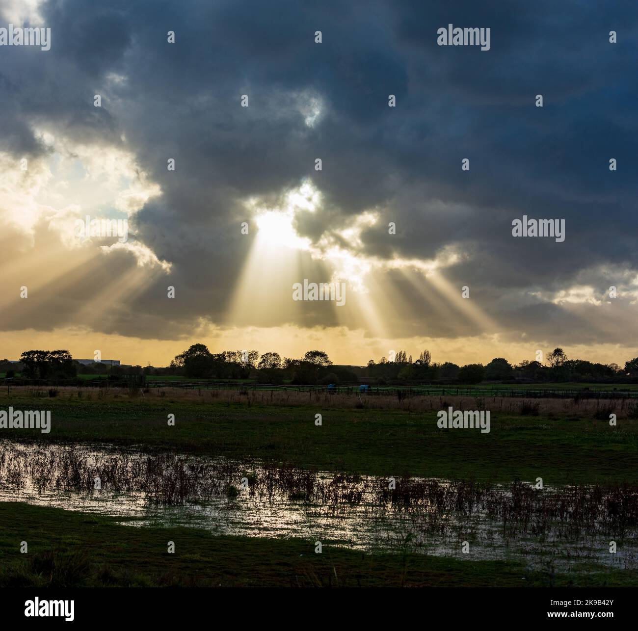 Dramatic skies with sun rays breaking through showing the end of the ...