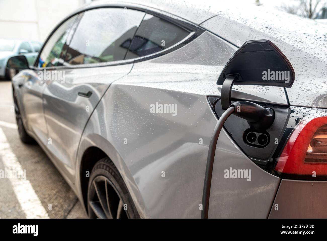 Electric car charging in station. at parking lot. Modern EV Stock Photo ...