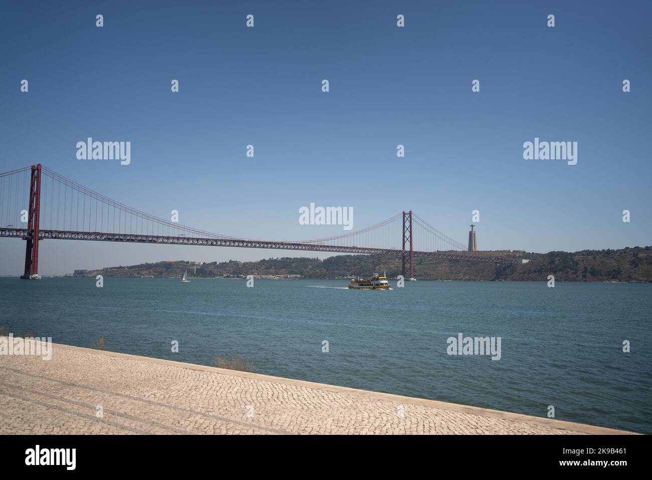 Motor boat passing underneath a long bridge Stock Photo - Alamy