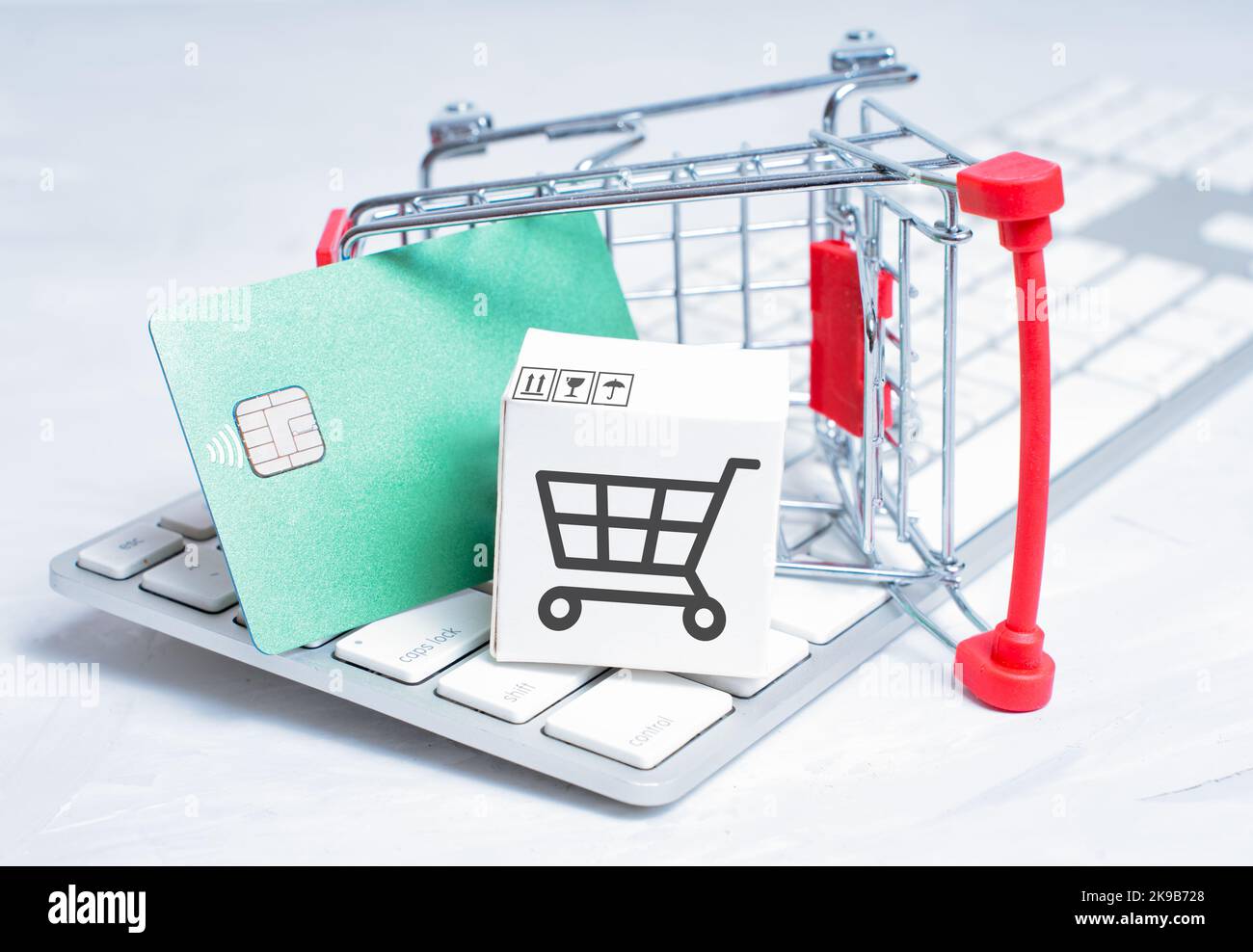 E-commerce related concept: toy shopping trolley with credit card and ...