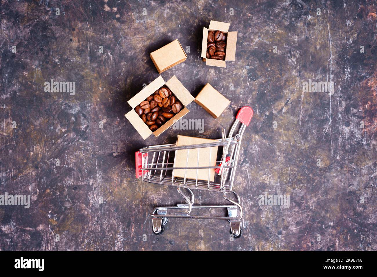 Teeny-tiny cardboard boxes with roasted coffee beans by an overturned ...