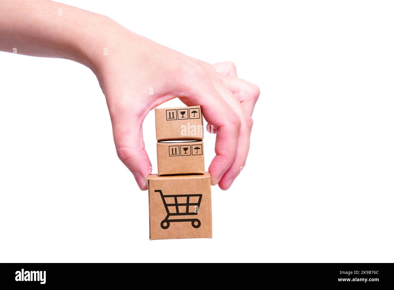 Group of tiny delivery packages labeled with shipping symbols in hand ...