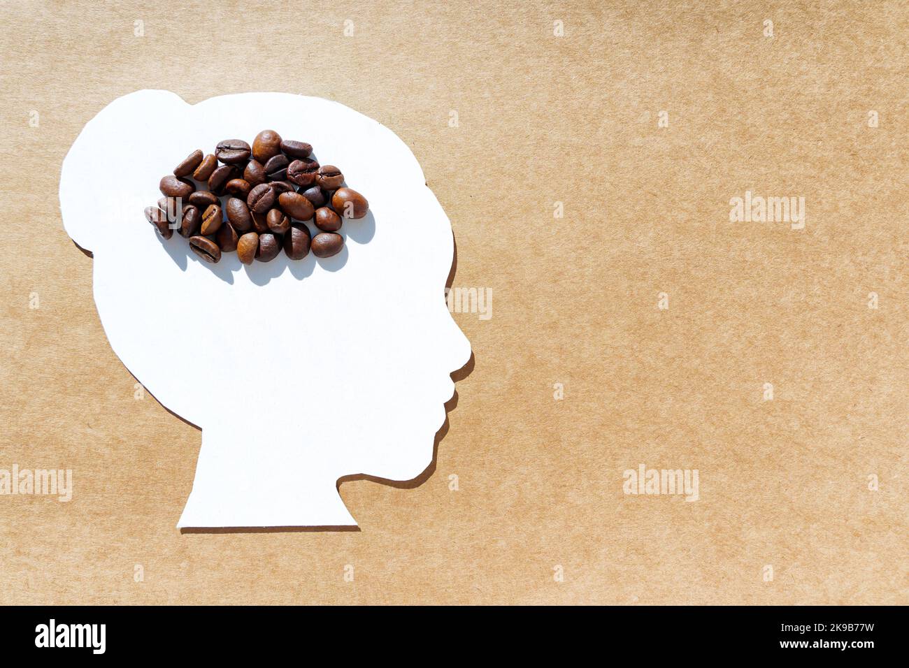 Female head profile shape paper cut-out with roasted beans isolated on ...