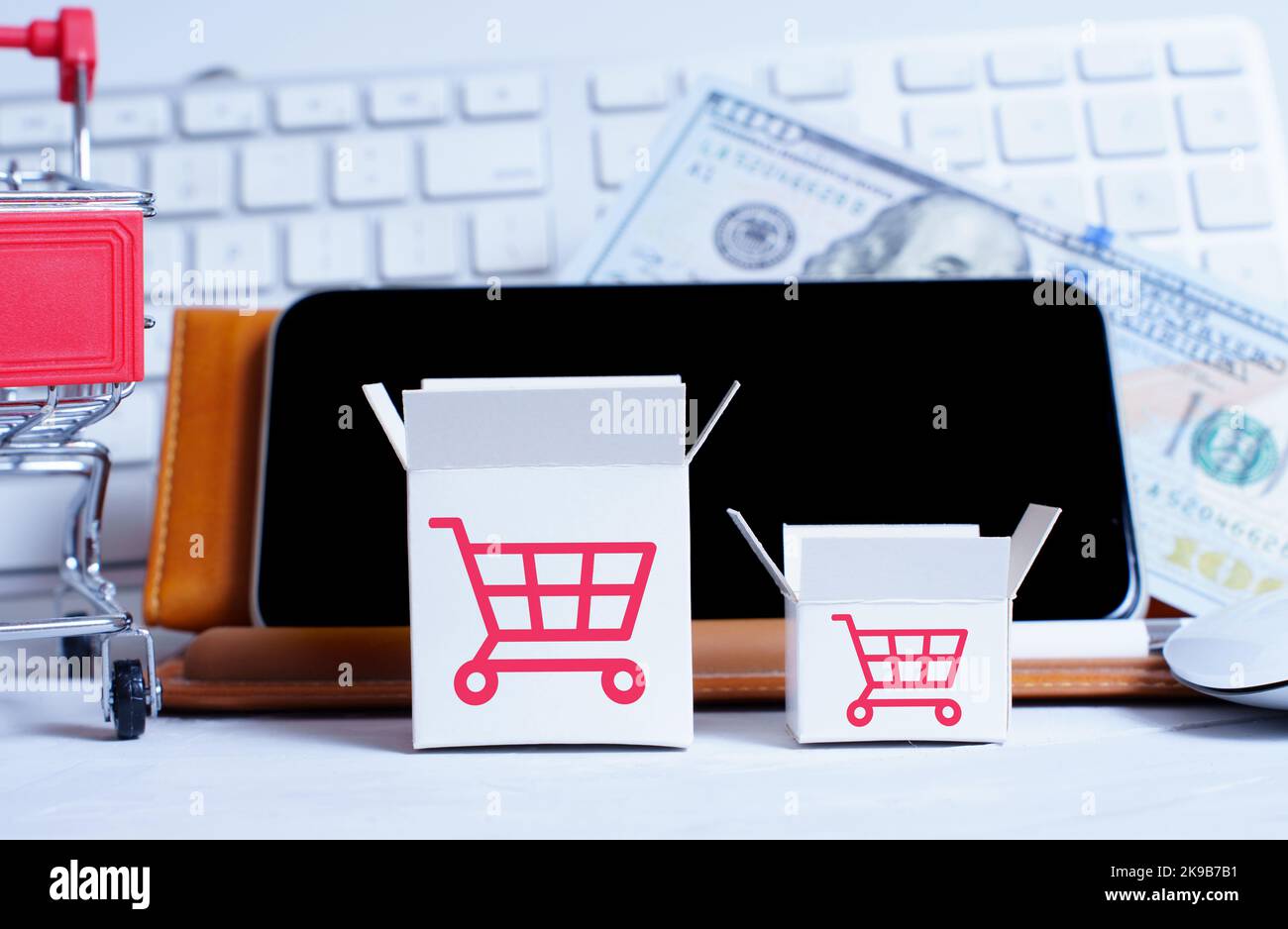 Small boxes marked with shopping cart symbol, smartphone, keyboard ...