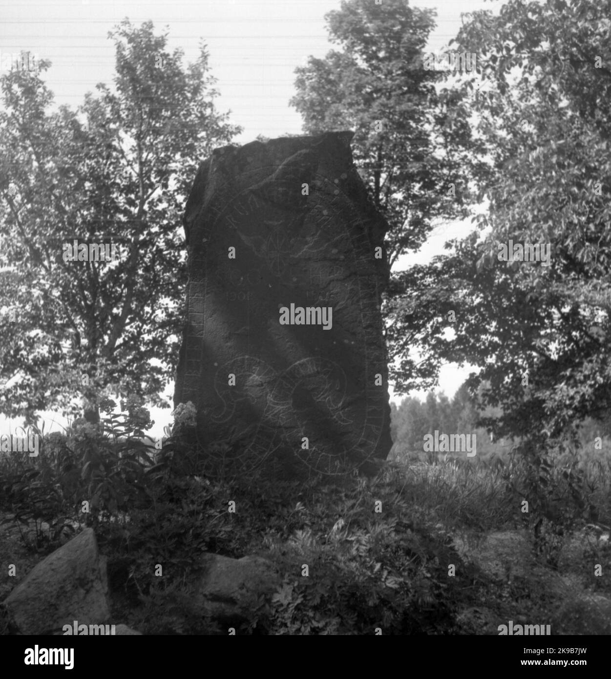 Runsten at Runhällen with winged wheels. inscription SGG (Sala-Gysinge ...