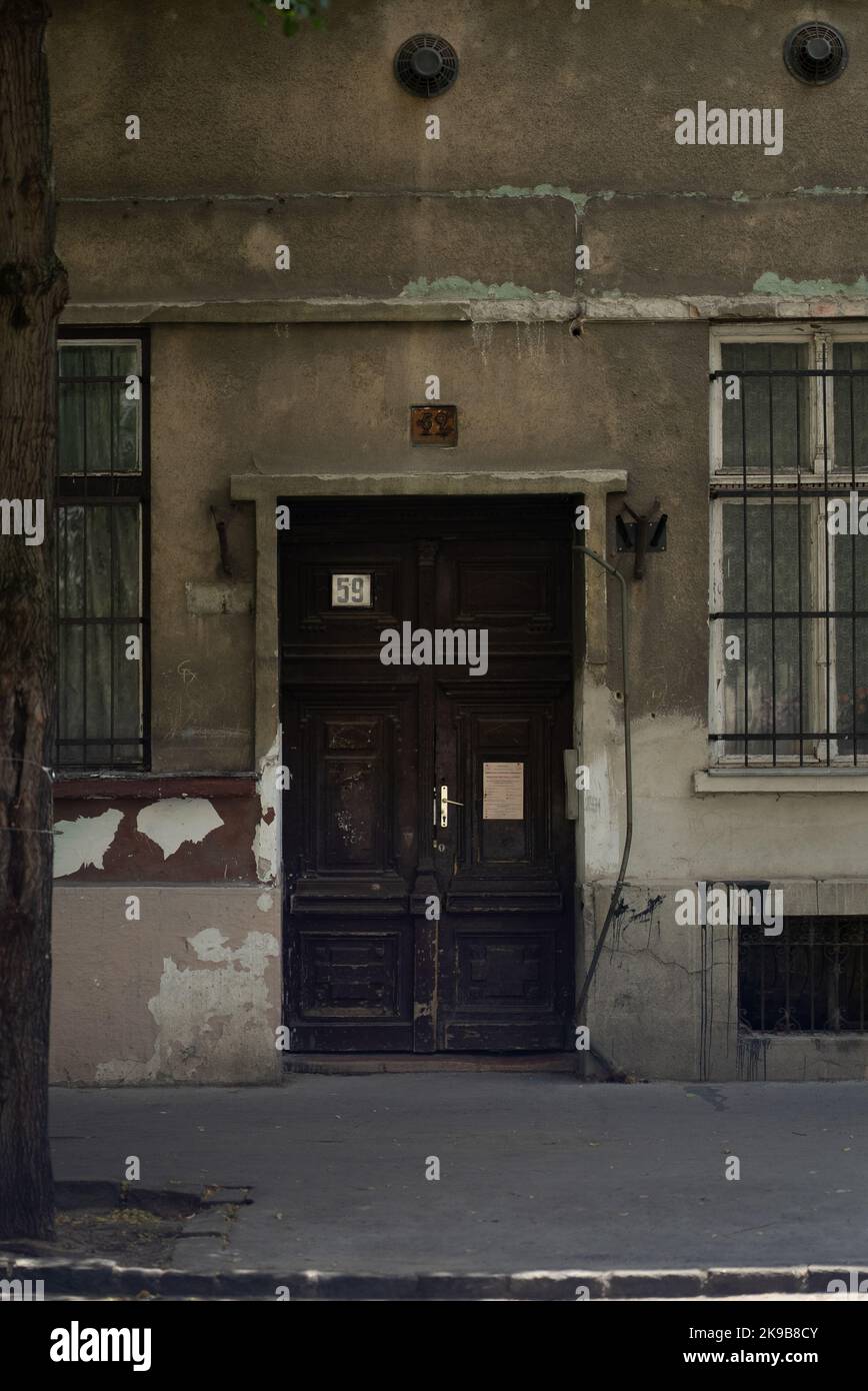 Fancy old door on the front of a worn down building Stock Photo - Alamy