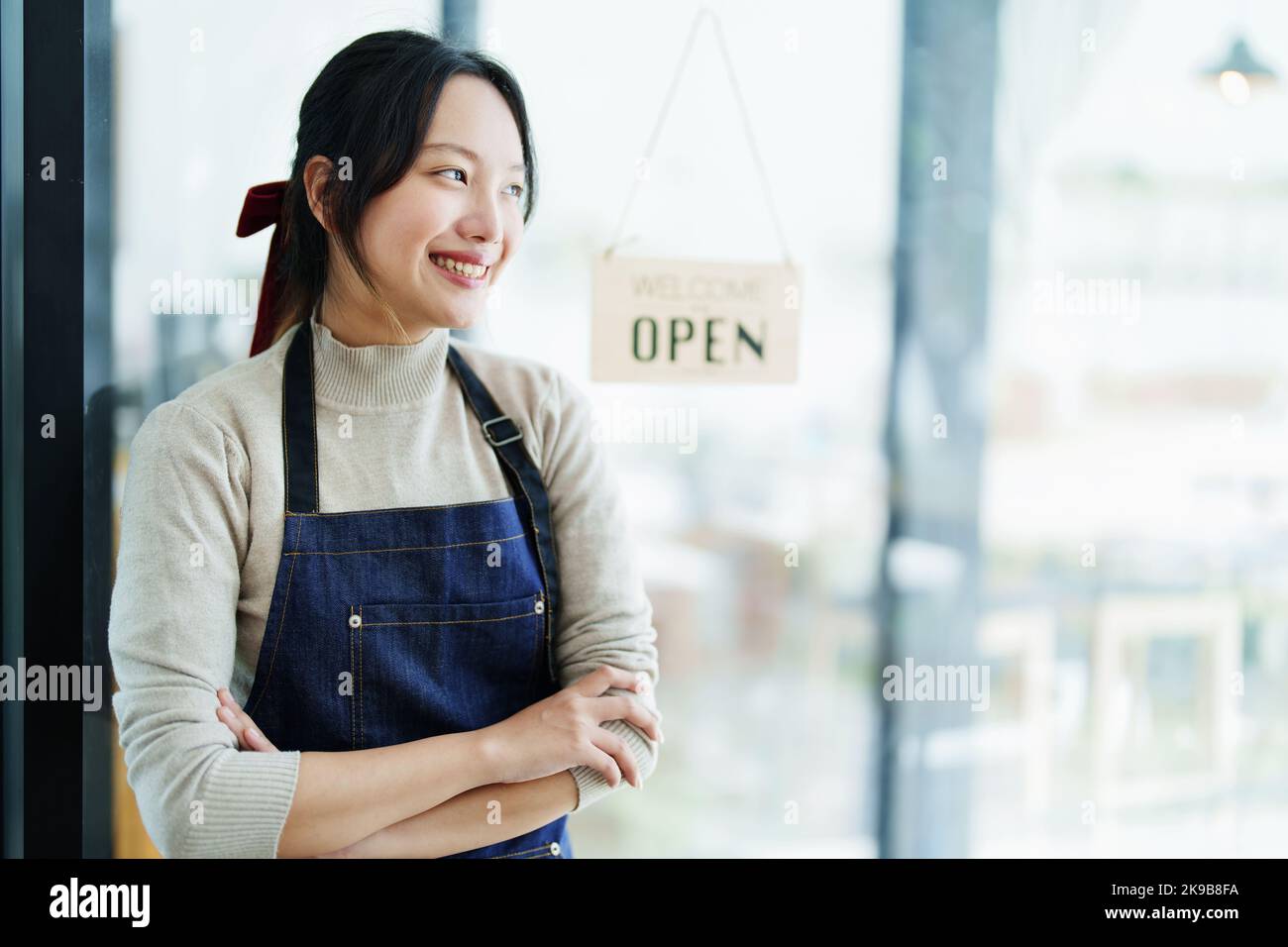 Starting and opening a small business, a young Asian woman showing a ...