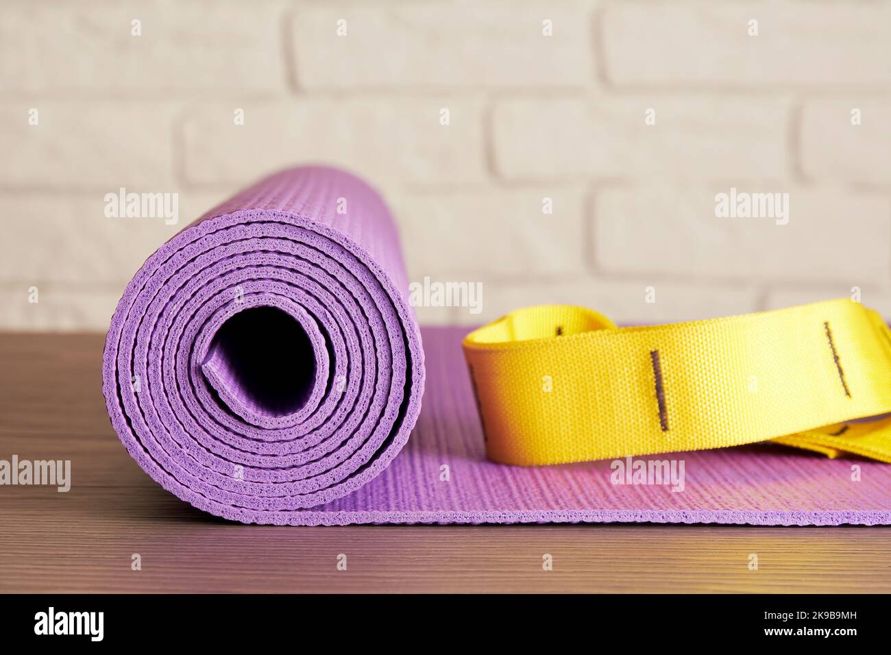 Yoga mat and belts on the floor in the modern gym. Sports and fitness ...