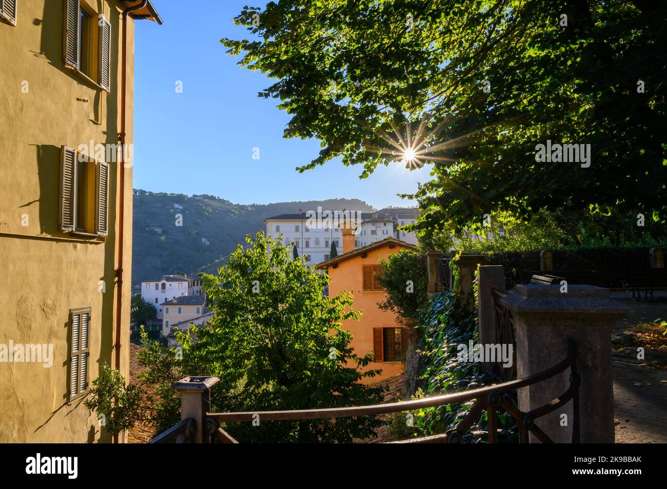Traditional and noble stone houses, hillside and the sun bursting ...