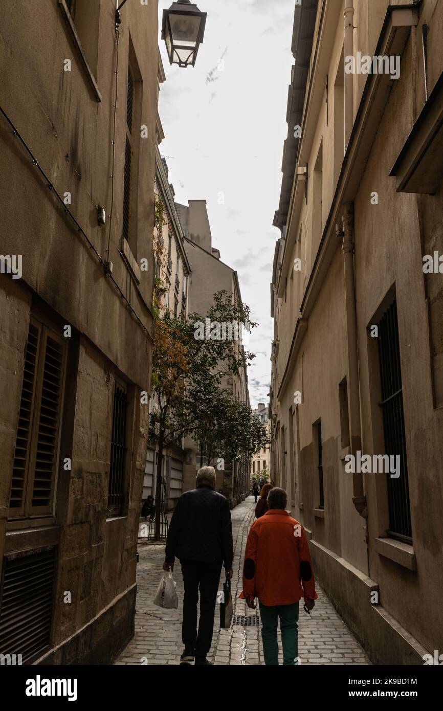Narrow alley with people Stock Photo - Alamy