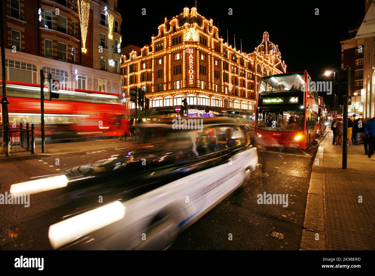 London, UK - December 8, 2012: Night View of Harrods, taxi present ...