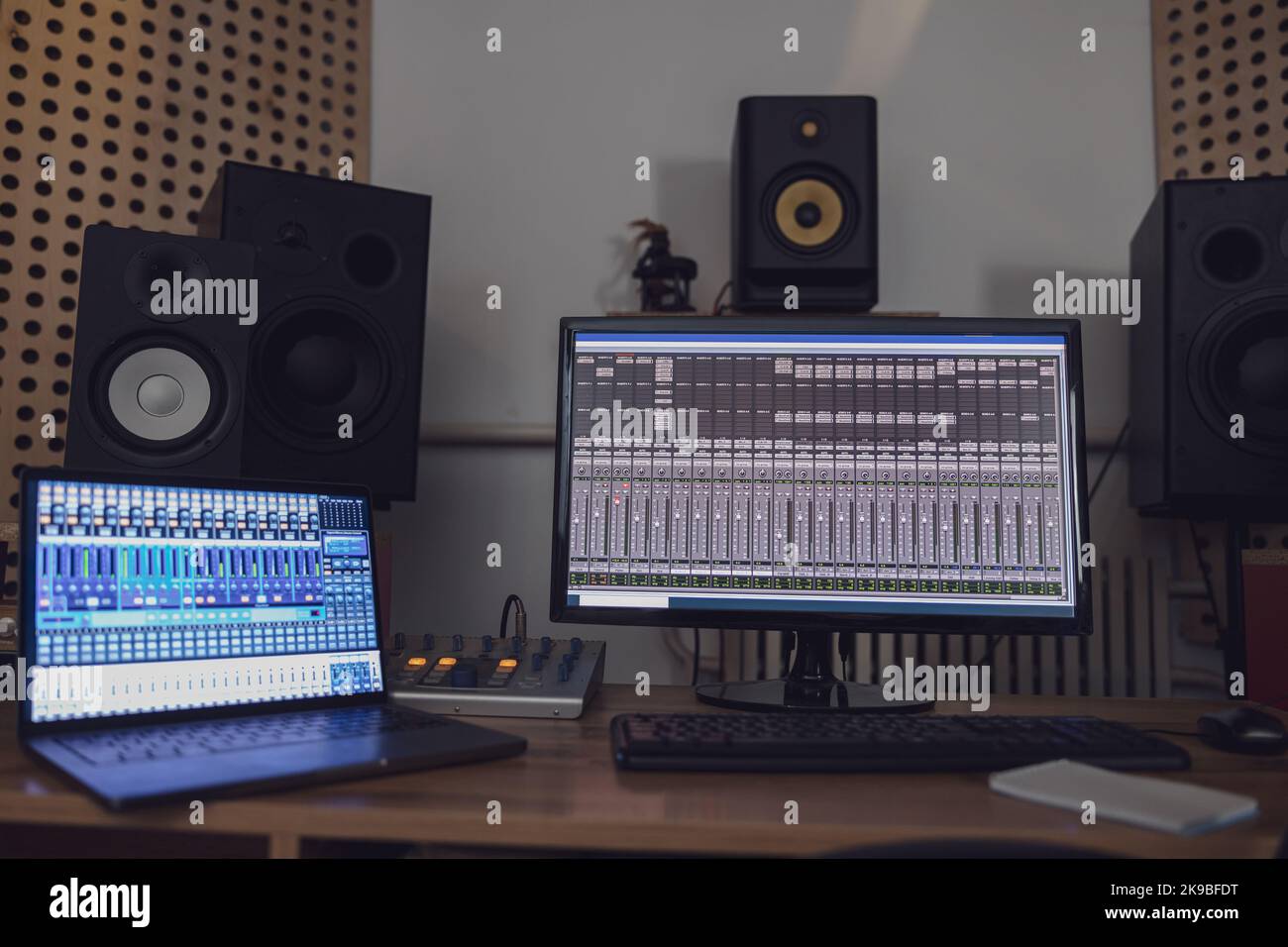 Overhead view of switched on laptop and monitor screen on table in a ...