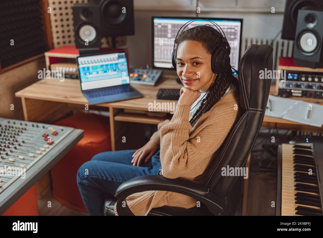 Pretty young multiethnic woman, musician, composer, sound engineer at ...