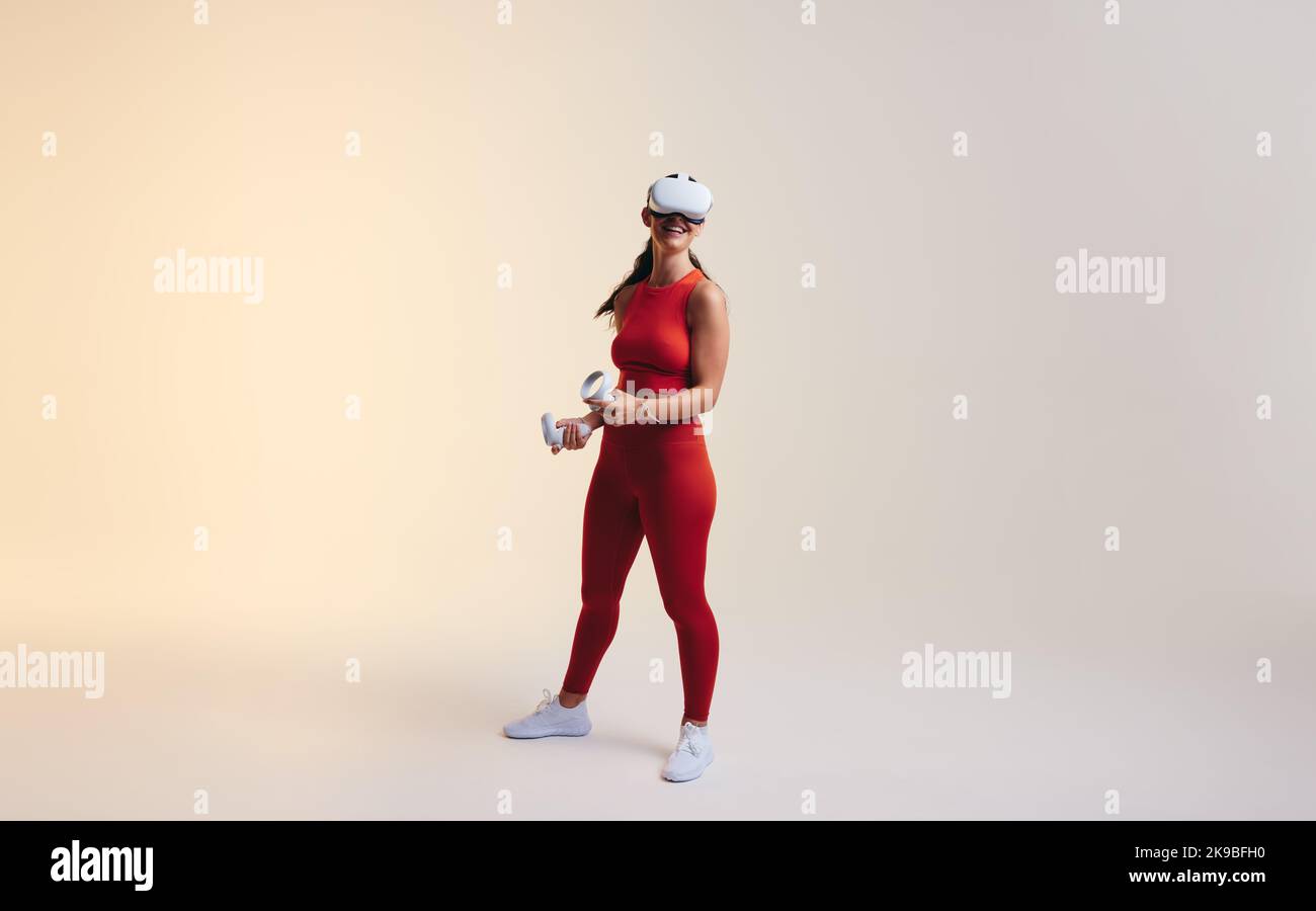 Female gamer enjoying an immersive virtual reality experience. Woman ...