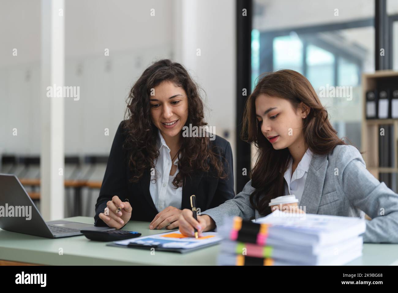 Diverse businesspeople cooperate work together discussing company financial statistics ...