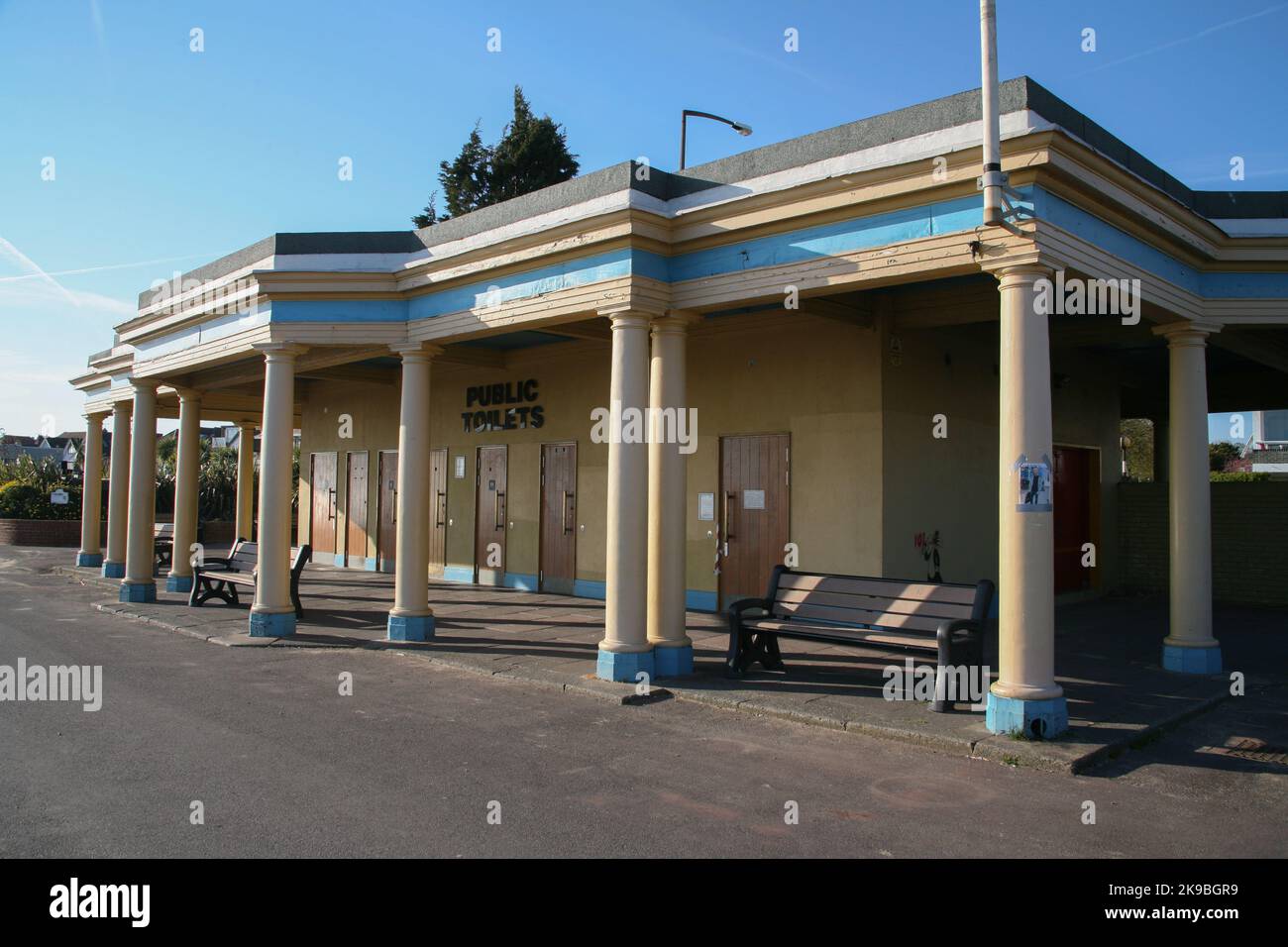 A public restroom building featuring classical columns and a flat roof ...