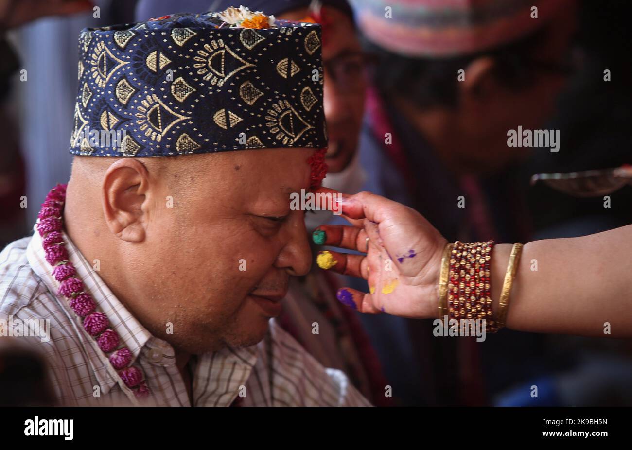 Kathmandu, Bagmati, Nepal. 27th Oct, 2022. A man receives colourful ...