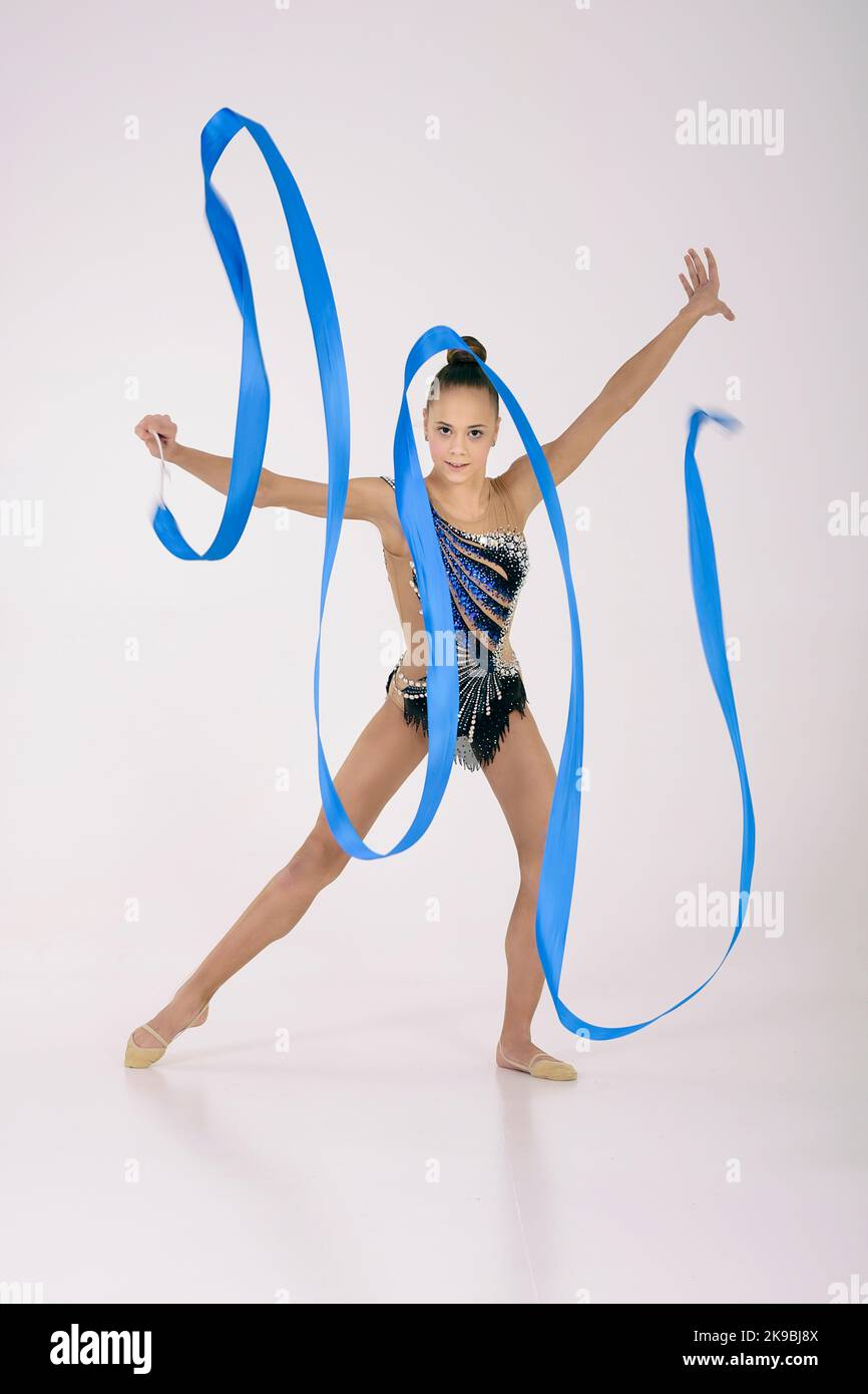 a girl from rhythmic gymnastics in a standing bodysuit shows an ...