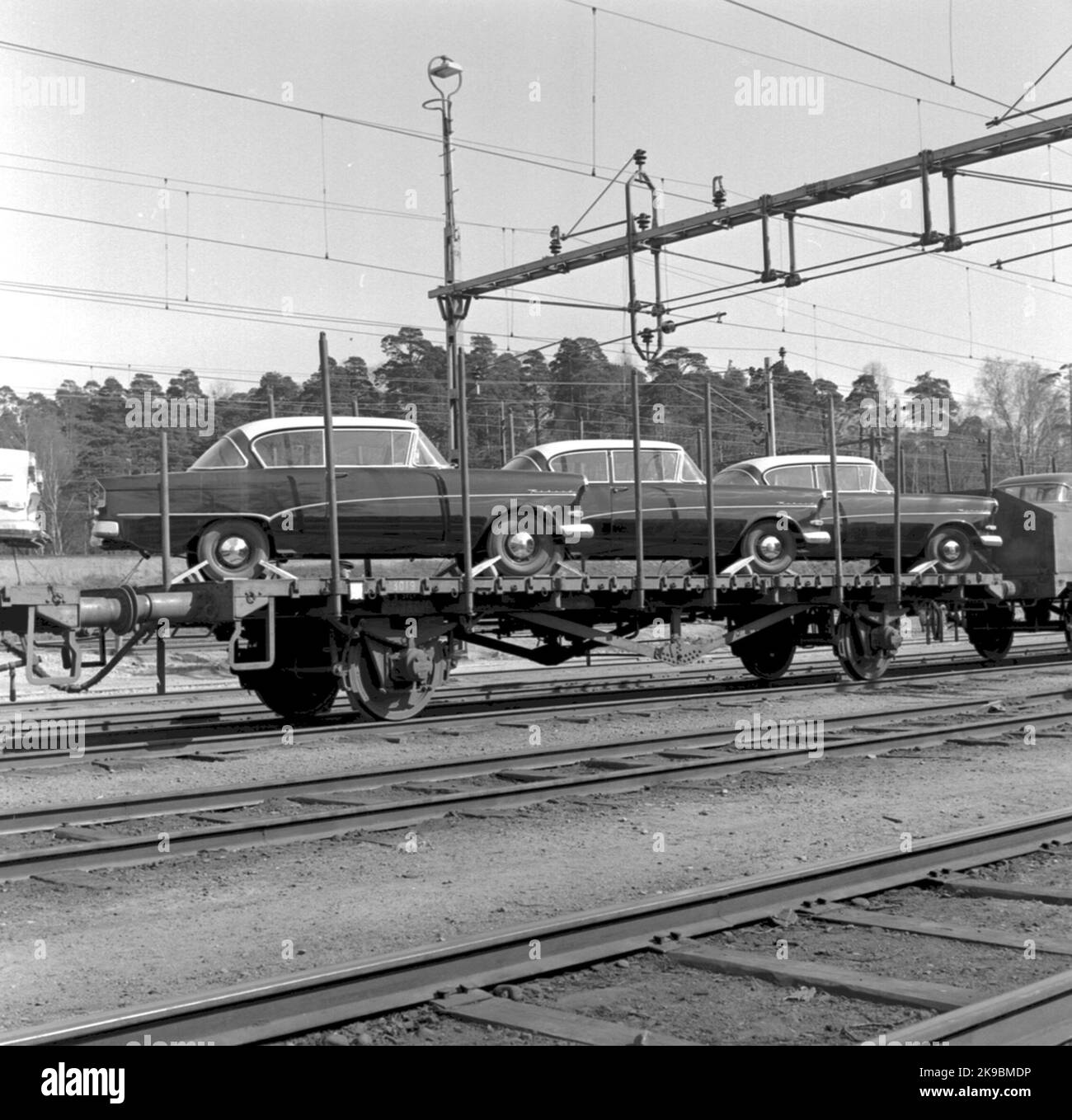 Passenger cars loaded on open carriage Stock Photo - Alamy