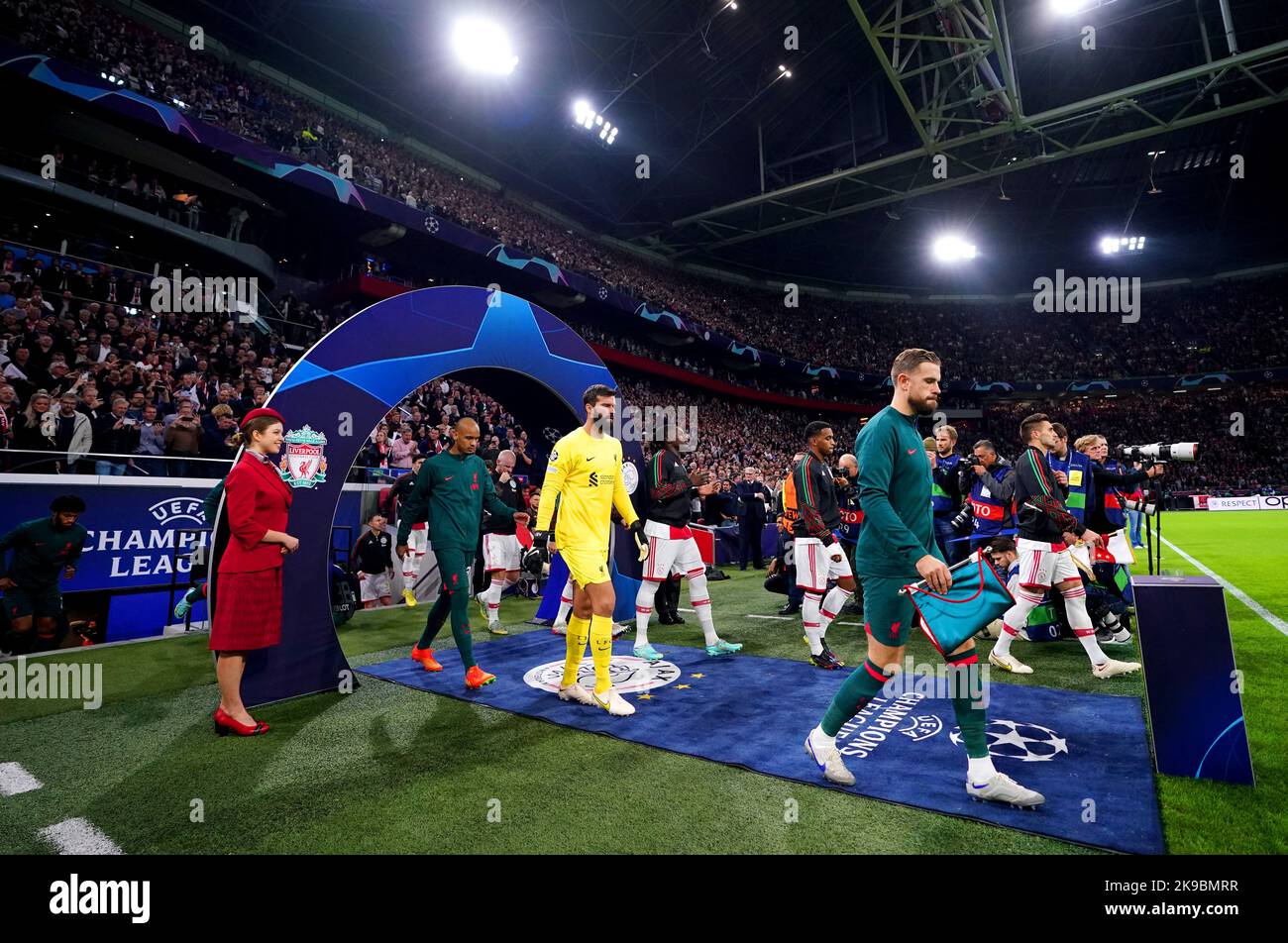 Liverpool's Jordan Henderson (right) makes his way out onto the pitch ...