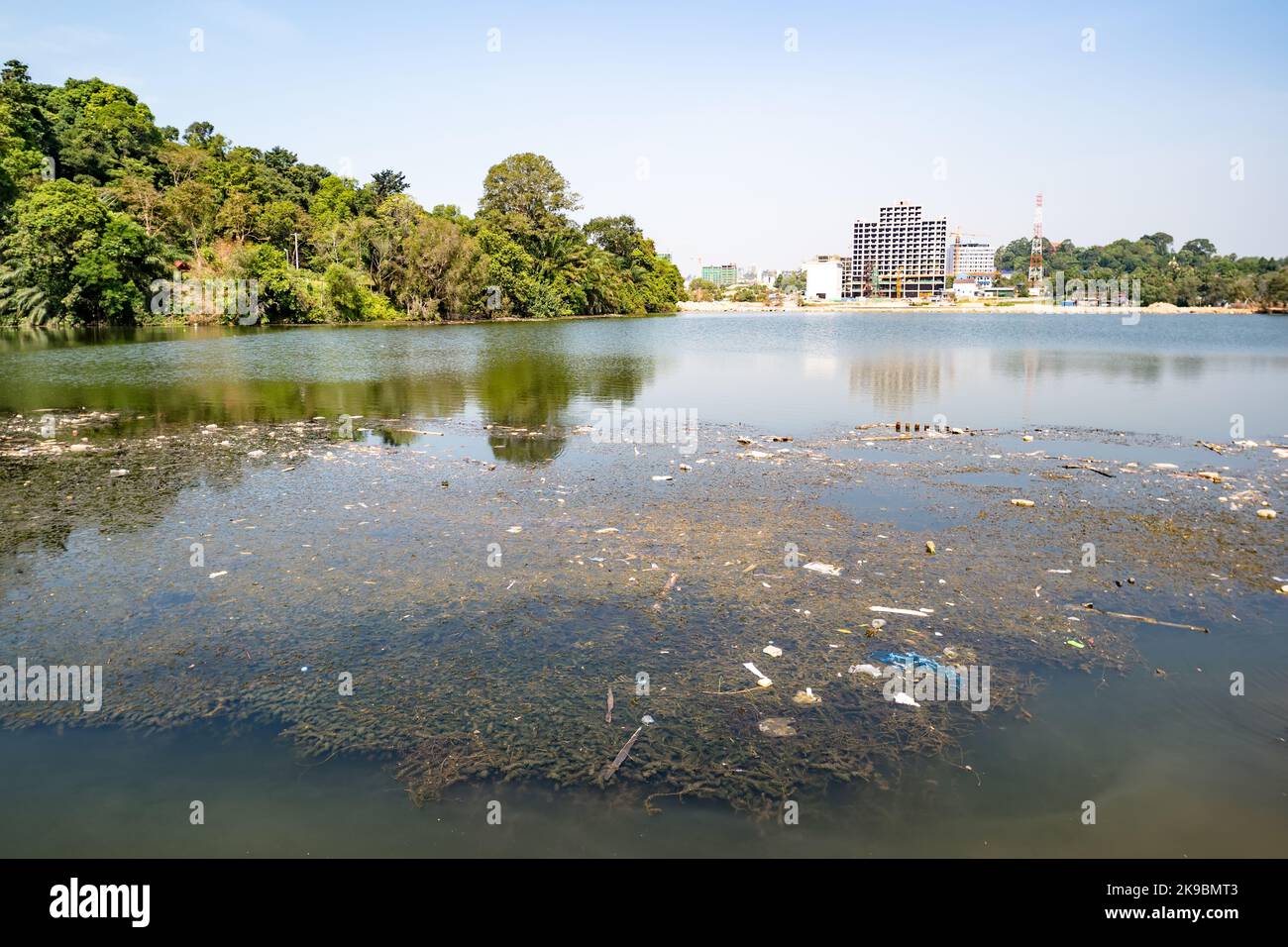 Environmental pollution in the city, human waste. Garbage in the pond ...