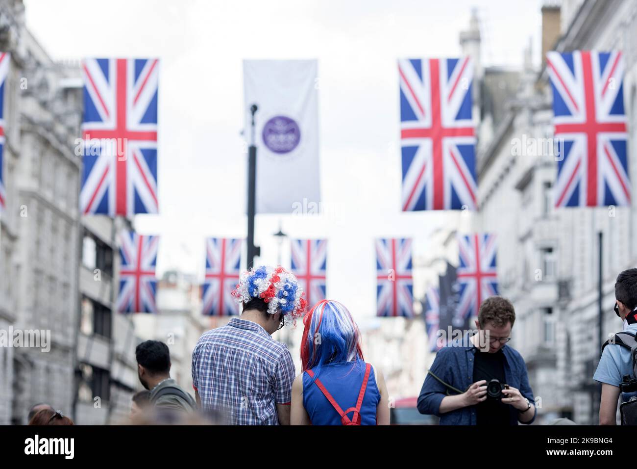 Revellers in Union Jack-themed costumes gather in Piccadilly Circus ...