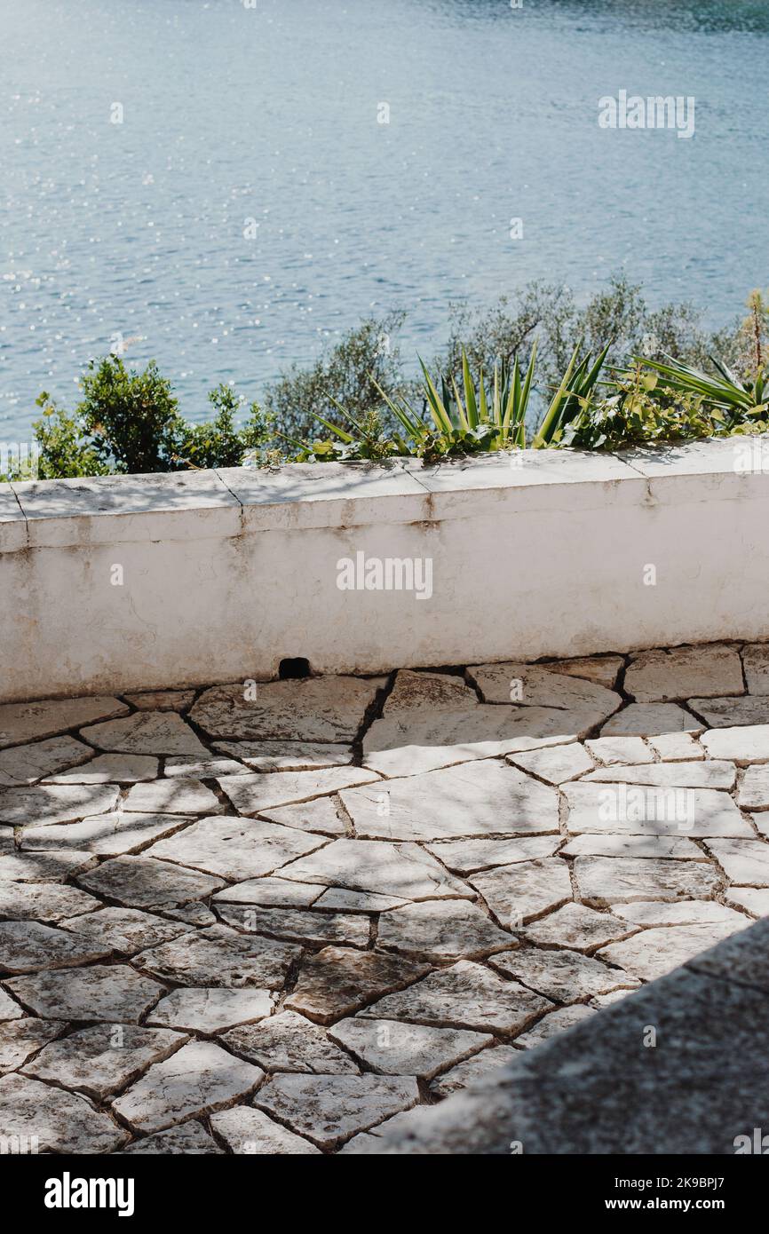 white concrete border for a tourist trail with green plants on it in a ...