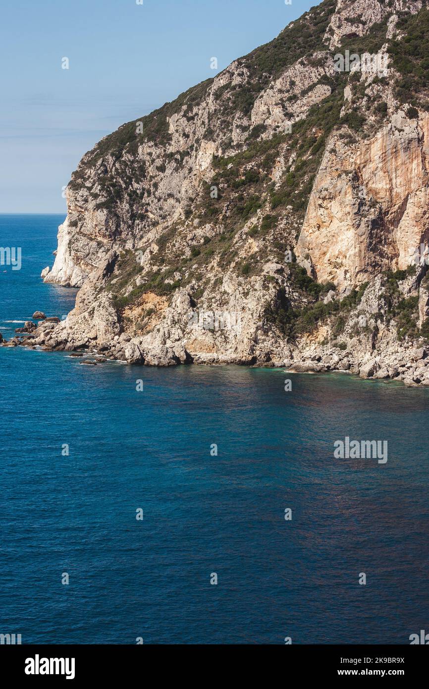 Corfu, Greece. A huge mountain rock on which green grows grows near ...