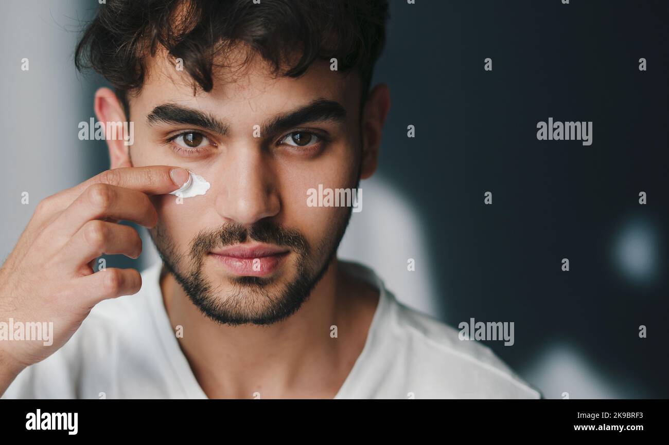 Close-up headshot view of a handsome young man standing in bathroom ...