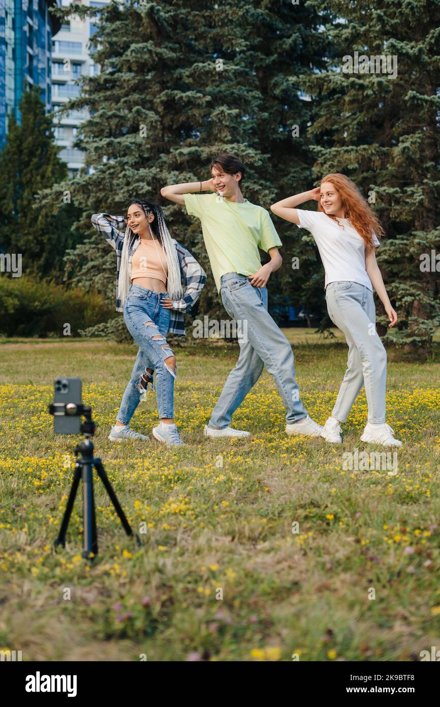 Young teenagers creating their dancing video by smartphone camera to ...