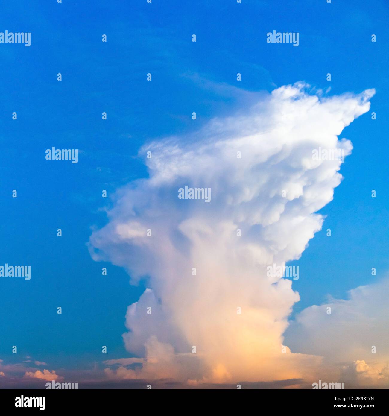 Vertical shaped white cloud is in blue sky. Natural square background ...