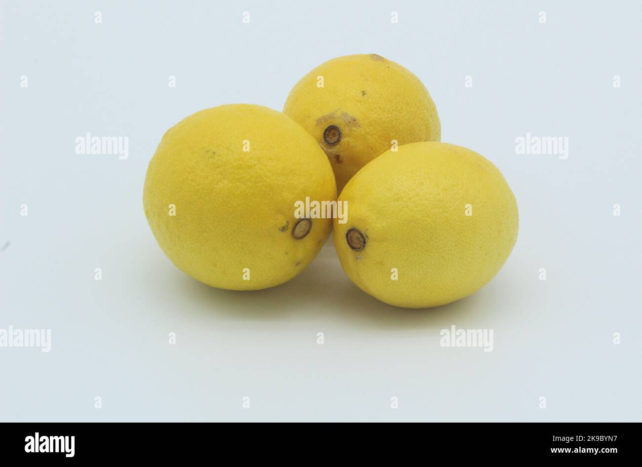 Group of ripe whole yellow lemon citrus fruit isolated on white ...
