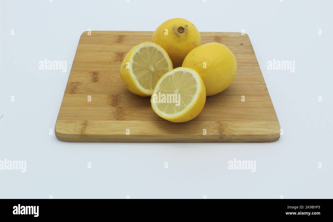 Group of ripe whole yellow lemon citrus fruit with lemon fruit half ...