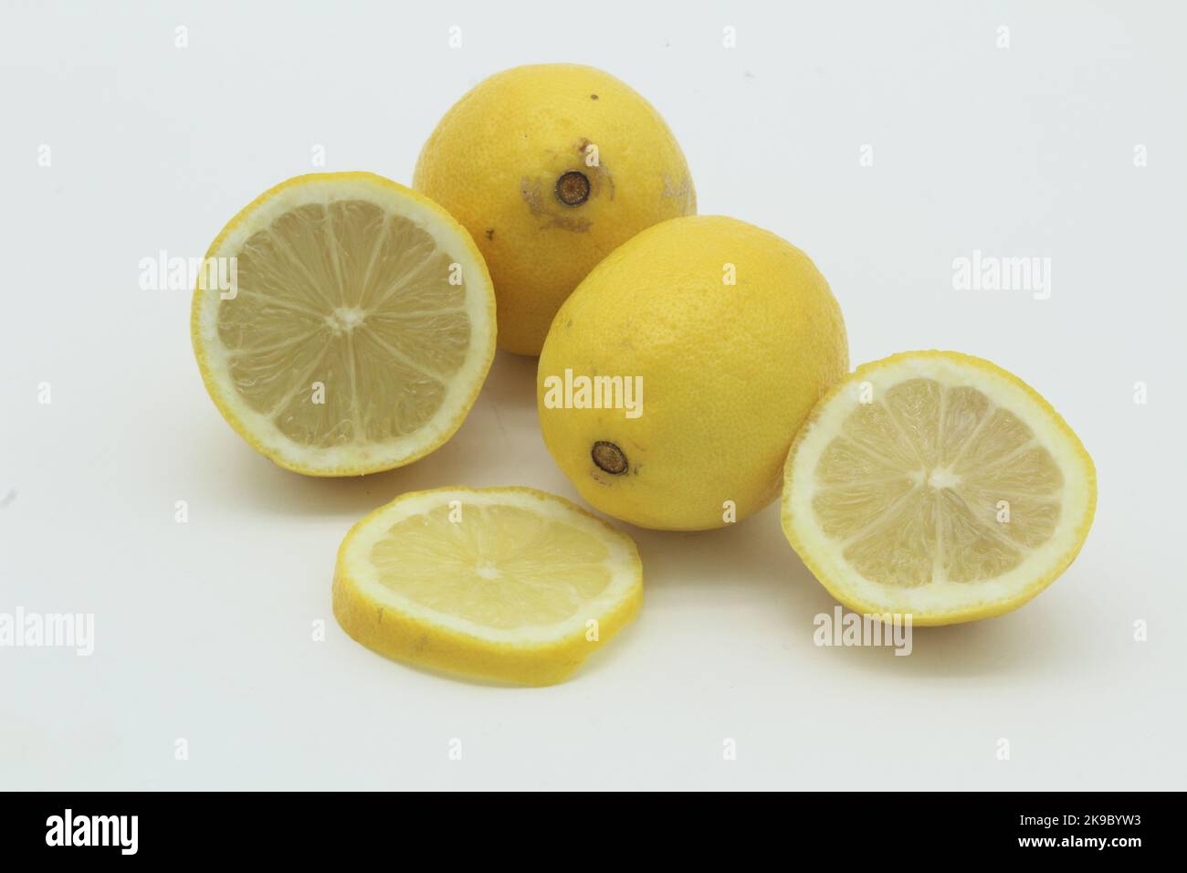 Group of ripe whole yellow lemon citrus fruit with lemon fruit half ...