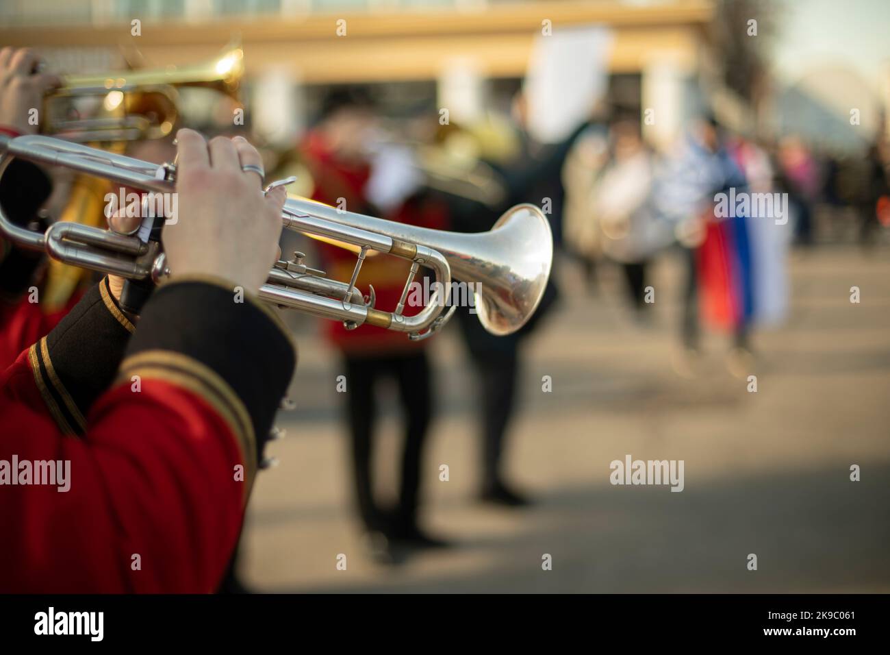 Orchestra with wind instruments. Trumpeters in ceremonial uniforms. Red ...