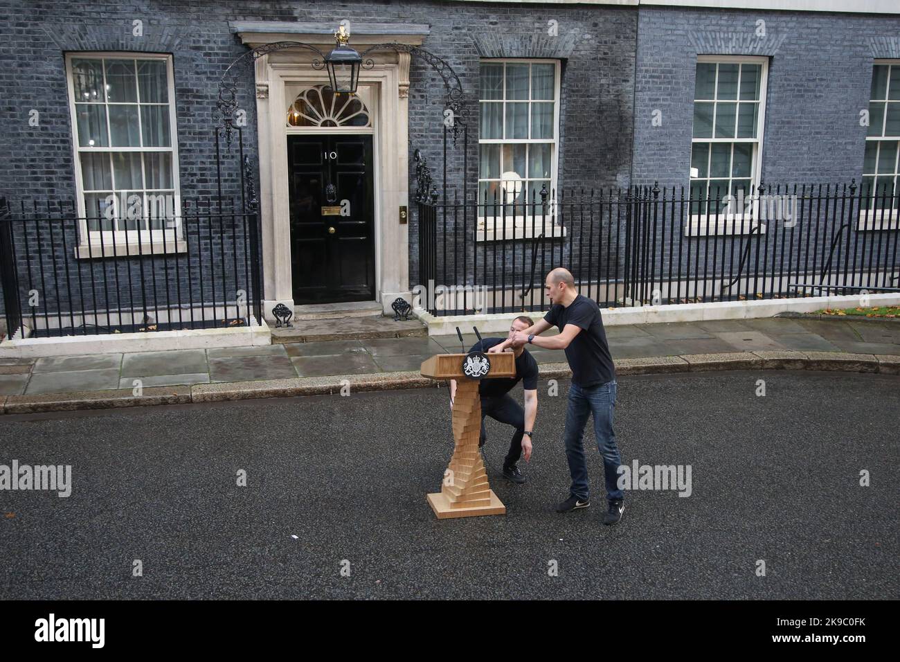 Members of the Downing Street staff set up the lectern for the out ...
