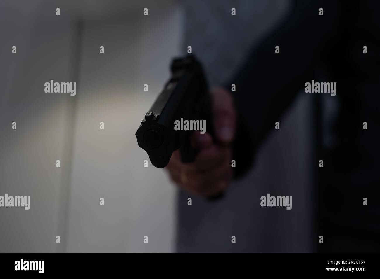 Mans hand holding gun hi-res stock photography and images - Alamy