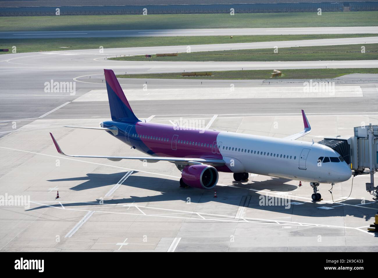 Jet airplane jumbo docked at airport gateway for unloading and loading ...