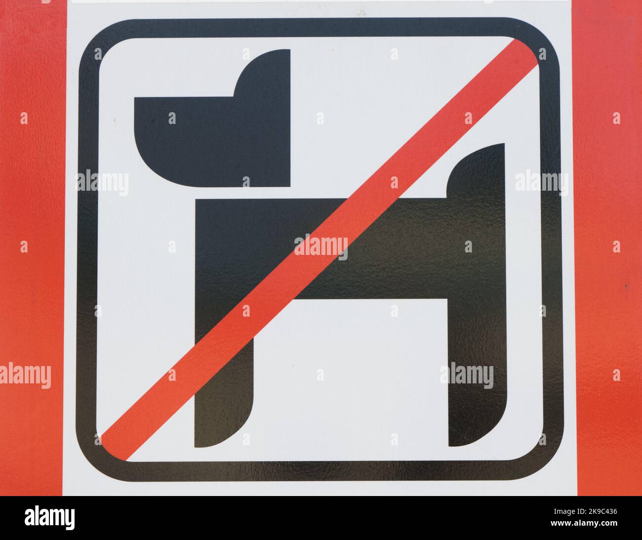 Close-up photo of a sign with a dog crossed out in red announcing a ...